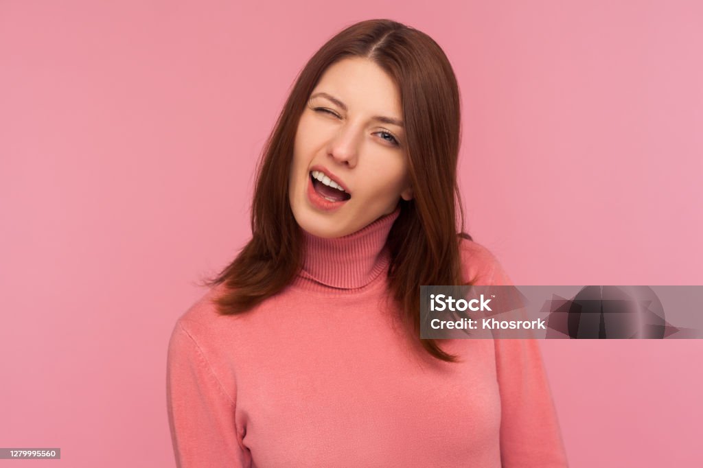 Closeup Portrait Of Coquettish Funny Brunette Woman In Pink Sweater