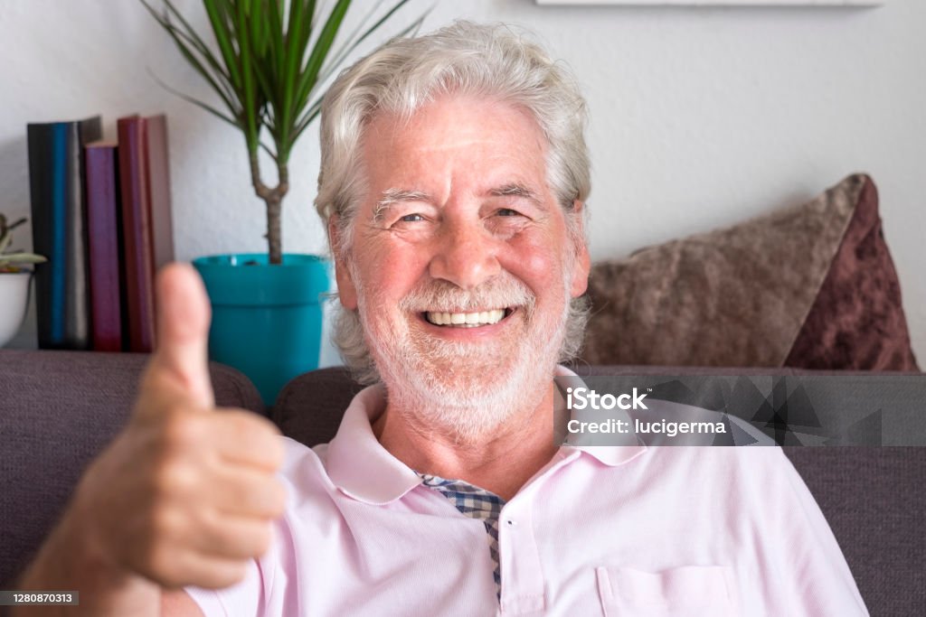 Portrait Of Attractive Bearded Senior Man With White Hair Sitting On