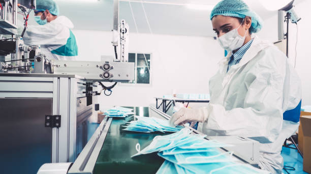 Free Stock Photo of Workers producing surgical masks in modern factory ...