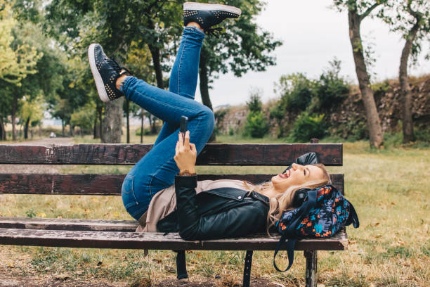 Free Stock Photo of Woman Laying on Bench With Crossed Legs | Download ...