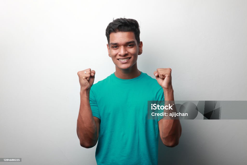Happy Young Man Of Indian Origin With A Cheering Gesture Stock Photo ... Happy Young Man Of Indian Origin With A Cheering Gesture Stock Photo ...
