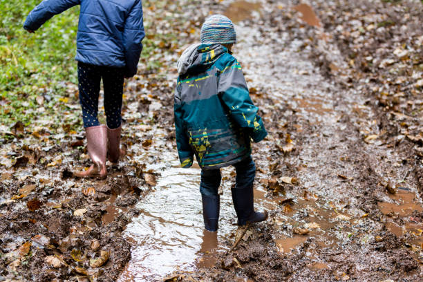 Free Stock Photo of Young children playing in puddle mud together ...