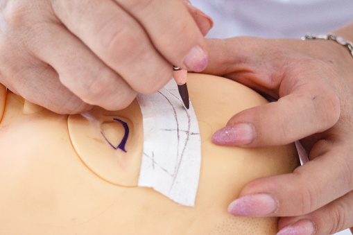Permanent Makeup Artist Practices Drawing Eyebrow On Mannequin Head ... Permanent Makeup Artist Practices Drawing Eyebrow On Mannequin Head ...