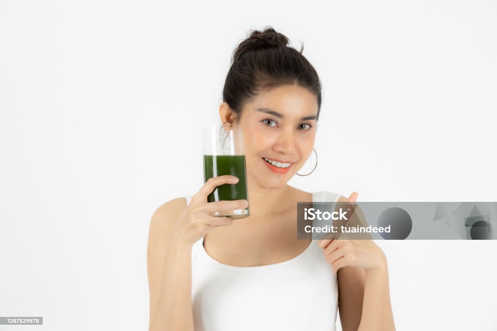 Beautiful Young Asian Woman Drinking Green Detox Vegetable Smoothie