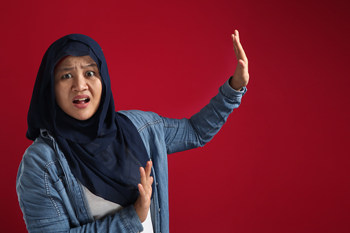 Asian Muslim Woman Wearing Hijab Rejecting Avoiding Something From The