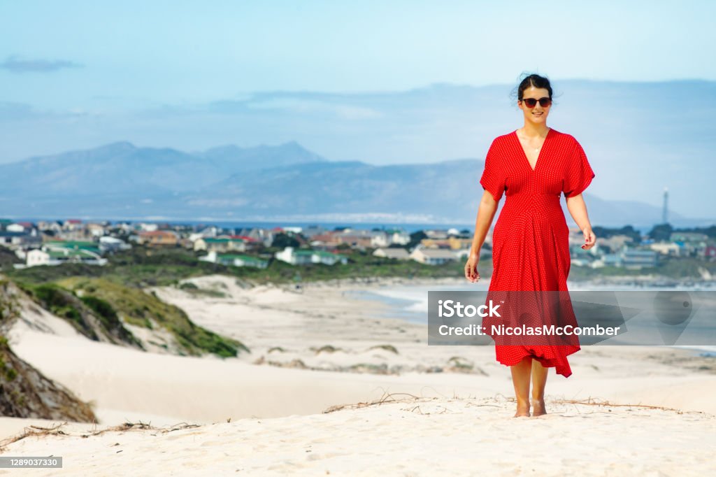 Young Woman In Red Dress Walking On South African White Sands Beach