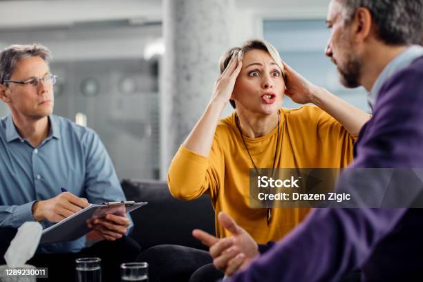 Frustrated Woman Arguing With Her Husband During A Meeting With