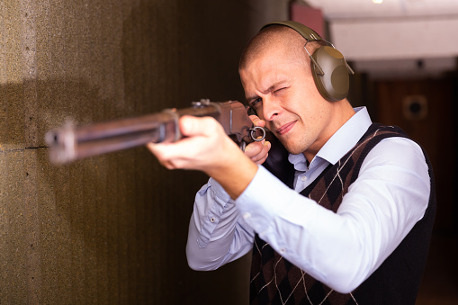 Focused Man Aiming Shotgun At Target In Shooting Range Stock Photo ... Focused Man Aiming Shotgun At Target In Shooting Range Stock Photo ...
