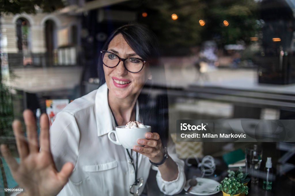 One Woman A Modern Mature Lady With Black Hair Is Drinking Coffee In A