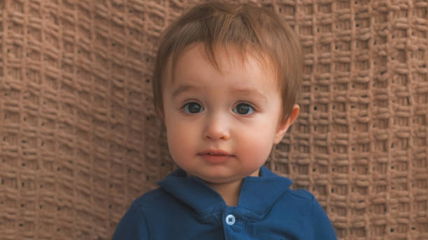 Cute Baby Boy With Brown Hair And Blue Eyes