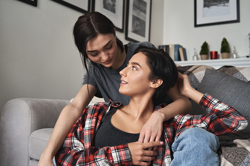 Two Young Affectionate Gen Z Women In Love Embracing At Home Beautiful