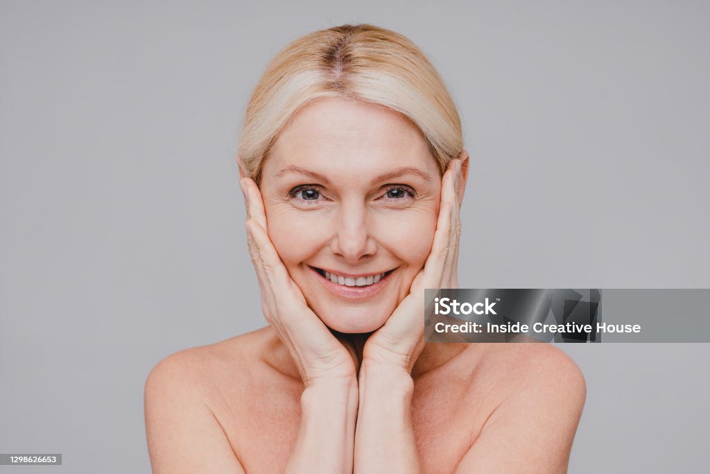Nicelooking Middleaged Caucasian Woman Smiling And Touching Her Fresh