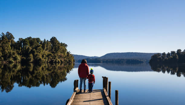 Free Stock Photo of Two friends enjoying a tranquil lakeside view ...