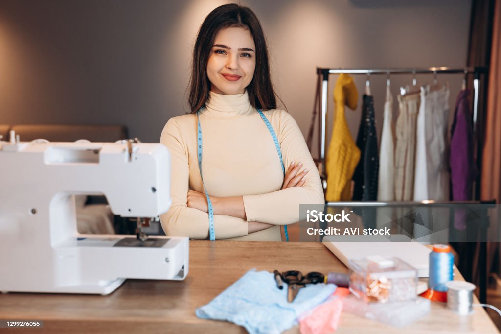Young Dressmaker Woman With Sewing Machine Seamstress Smiles In
