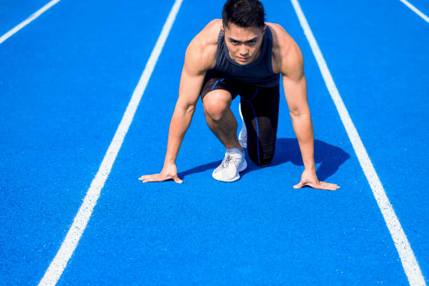Free Stock Photo of Athlete stretching on a running track | Download ...