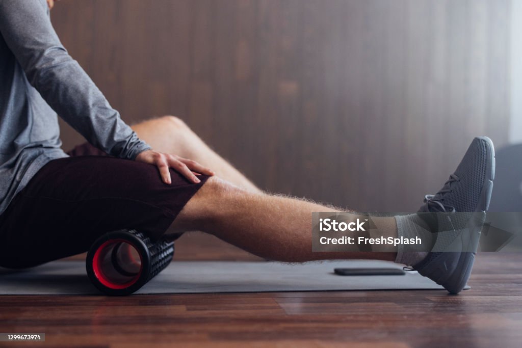 Roller Massage For Warming Up An Unrecognizable Fit Caucasian Sportsman Preparing To Work Out