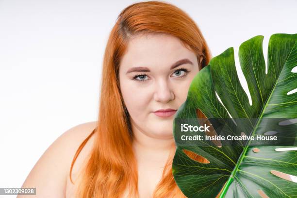 Nicelooking Fat Redhead Woman In Spa Towel With Tropical Leaf Isolated Over White Background