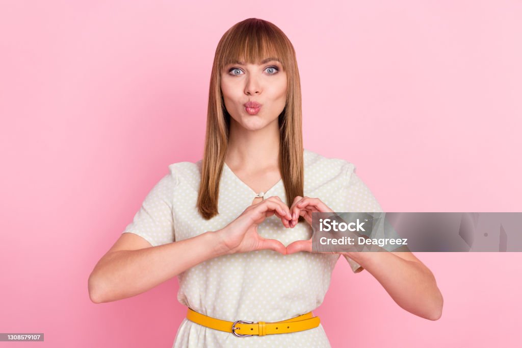 Portrait Of Attractive Amorous Girl Showing Heart Symbol Sending Air