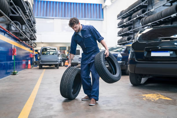 Free picture: A man carrying a big black inflated inner tires on his back