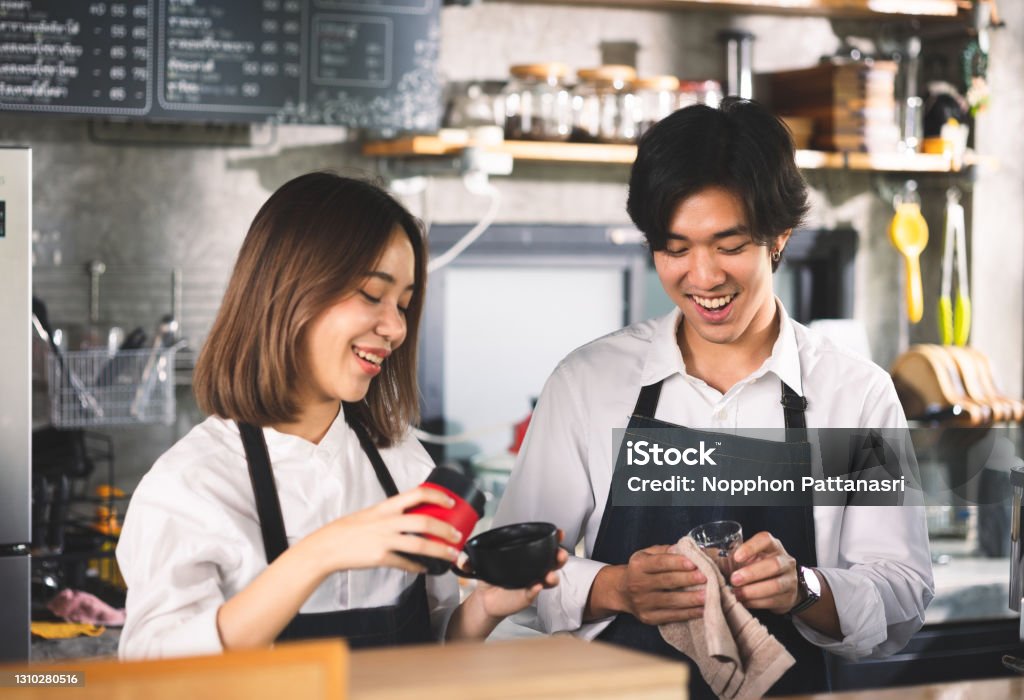 Two Asian Coffee Waitress Making Cup Of Hot Coffee Latte In Coffee Shop