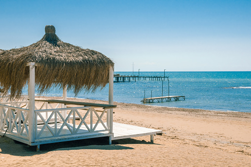 Massage Huts With Thatched Roof On Sand Beach Along Seaside Luxury
