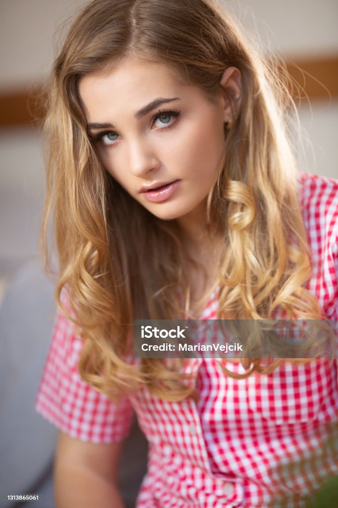 Beautiful Blonde Curly Haired Girl With Smooth Skin Looking Directly