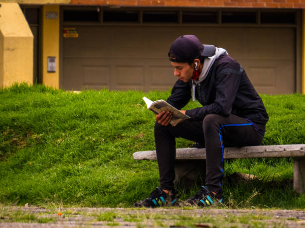 Free Stock Photo of Man Reading a Book on the Sidewalk | Download Free ...