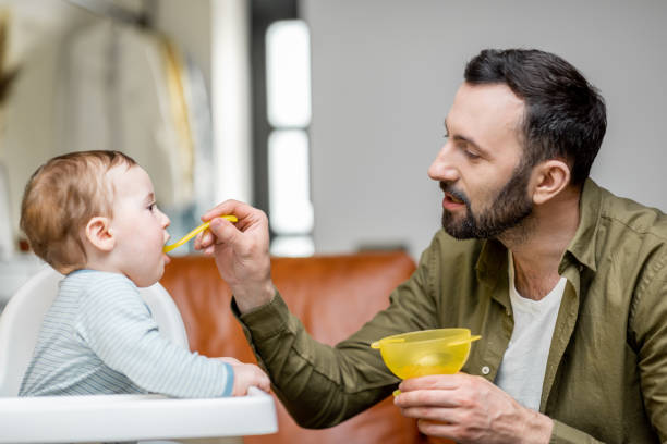 Free Stock Photo of Dad feeding his distracted son | Download Free ...