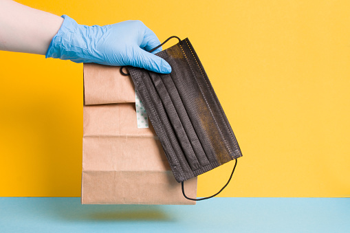 Contactless Food Delivery Concept A Couriers Hand In A Blue Rubber ... Contactless Food Delivery Concept A Couriers Hand In A Blue Rubber ...