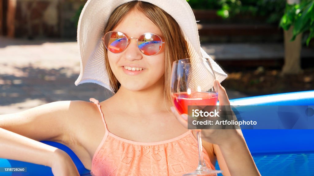 Happy Smiling Young Woman Drinking Cocktail From Straw While Relaxing