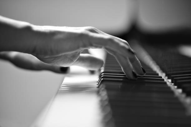 Black Hands Playing Piano