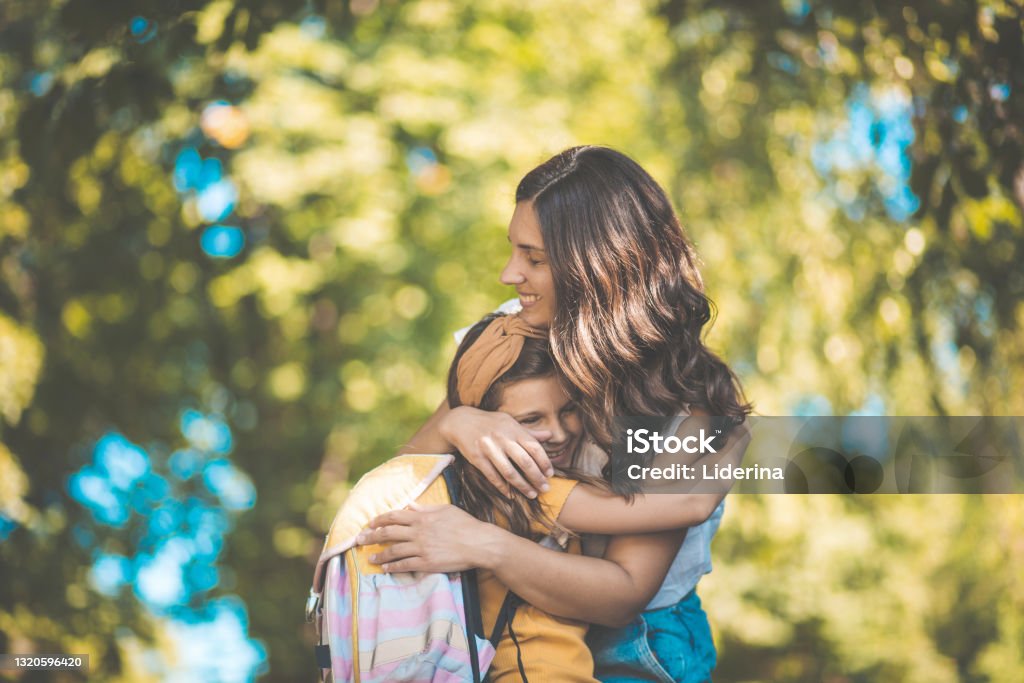 Mother Hugging Her Daughter And Standing In Nature Hug Of Love Stock