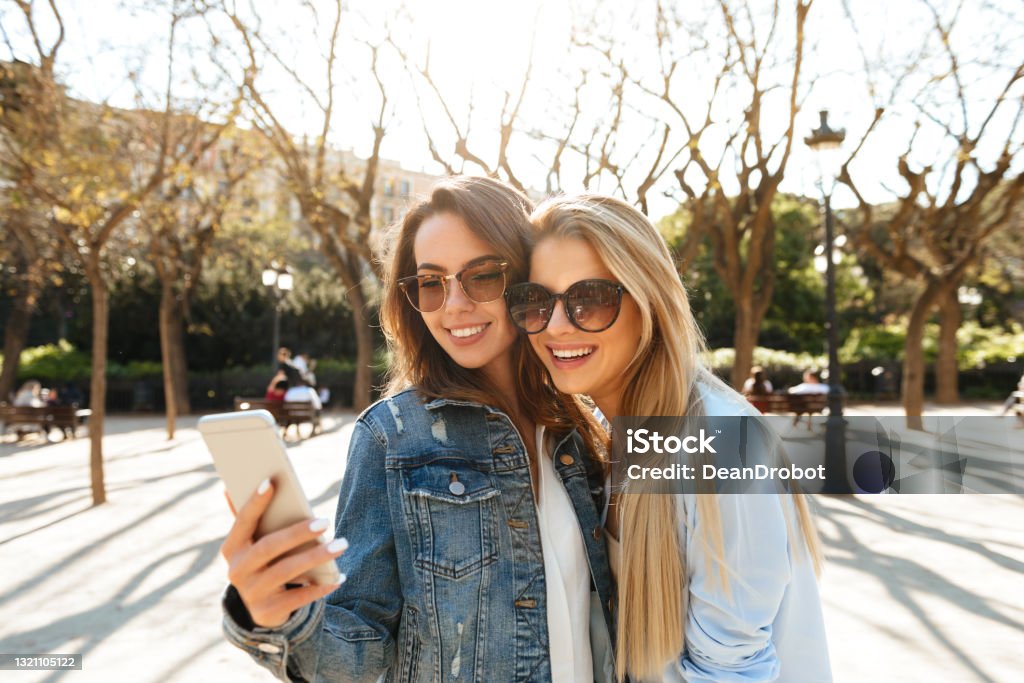 Two Amazing Smiling Women Friends Make Selfie By Mobile Phone Stock