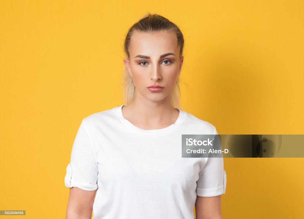 Serious Young Woman Wears White Tshirt Looking At Camera Isolated On