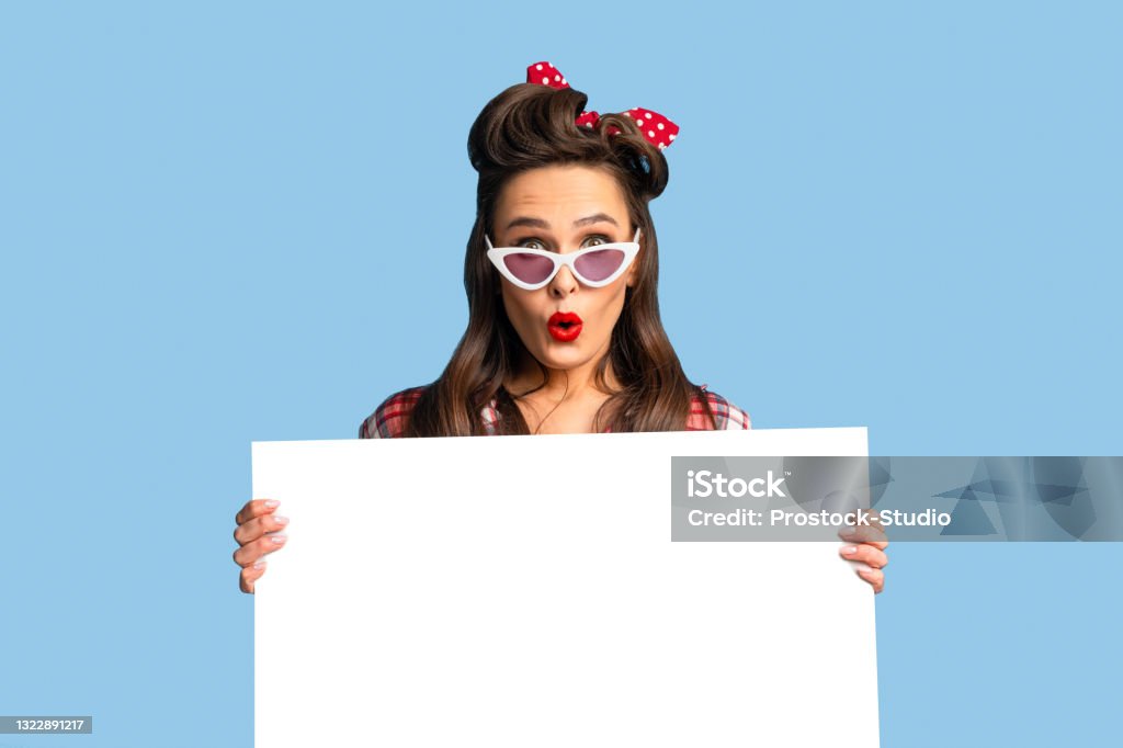 Shocked Pinup Woman In Retro Sunglasses And Plaid Shirt Presenting