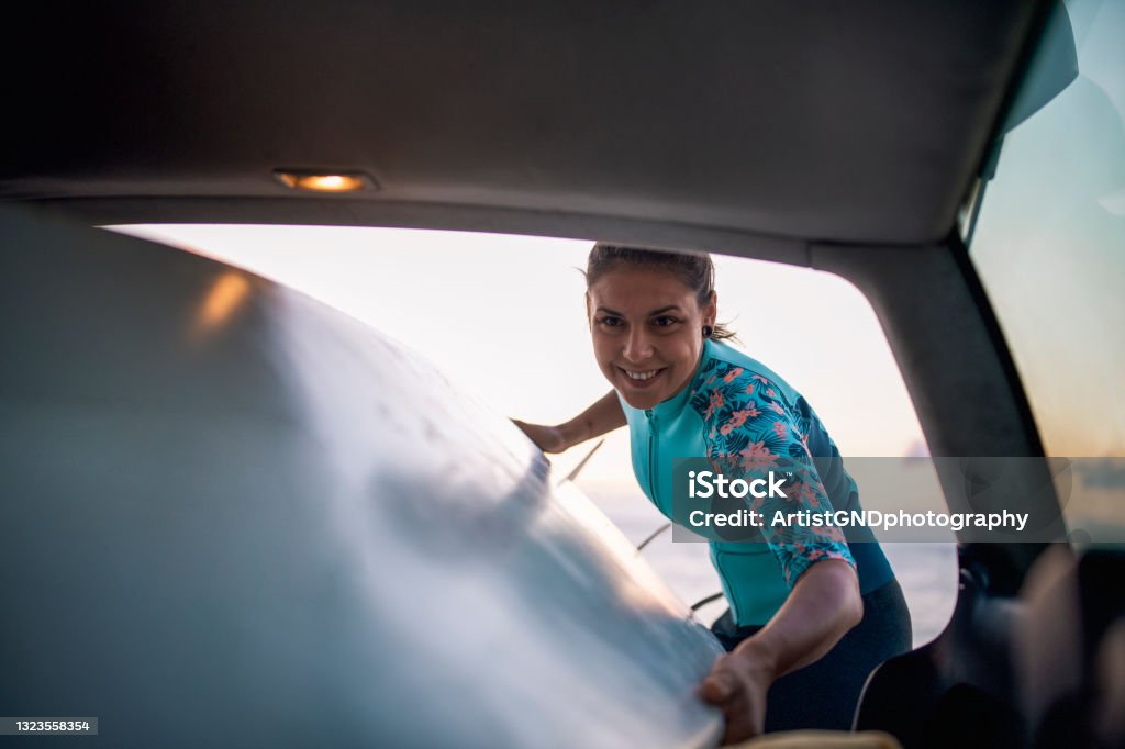 Woman Unloading Surfboard At Sunrise Stock Photo - Download Image Now ... Woman Unloading Surfboard At Sunrise Stock Photo - Download Image Now ...