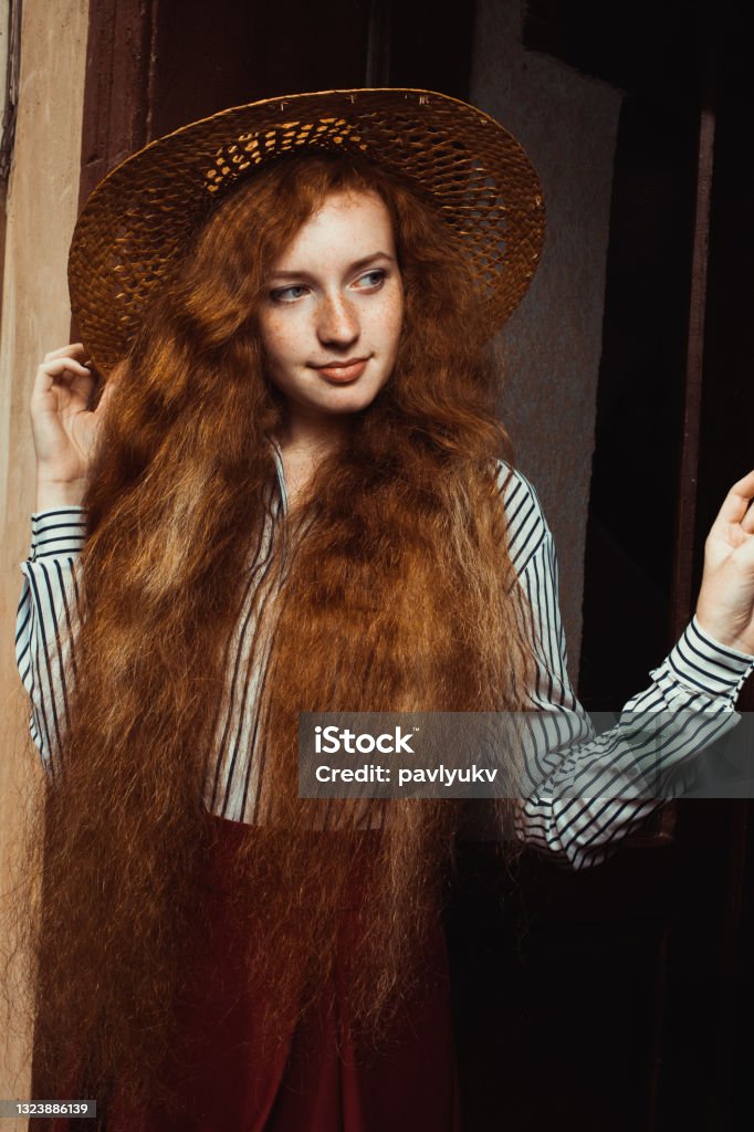 Lovely Young Red Haired Model With Freckles In Straw Hat Posing In