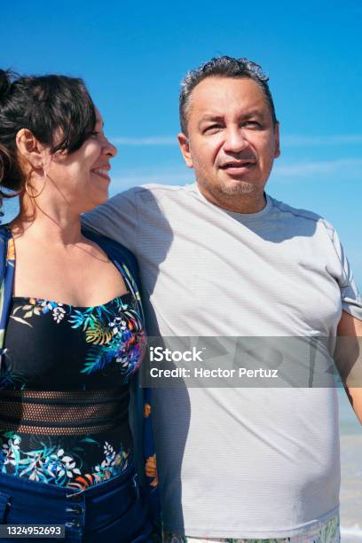 Mature Married Couple Hugging Each Other Standing At The Beach Stock