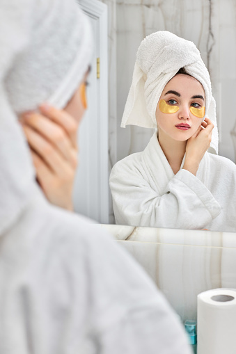 Beautiful Woman With Eye Patches In White Bathrobes In Bathroom Stock