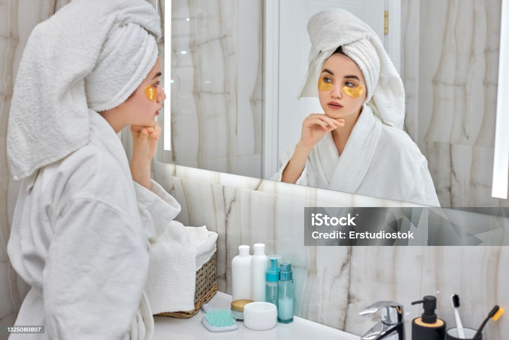 Beautiful Woman With Eye Patches In White Bathrobes In Bathroom Stock