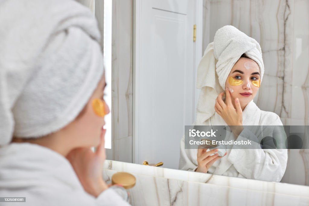 Beautiful Woman With Eye Patches In White Bathrobes In Bathroom Stock