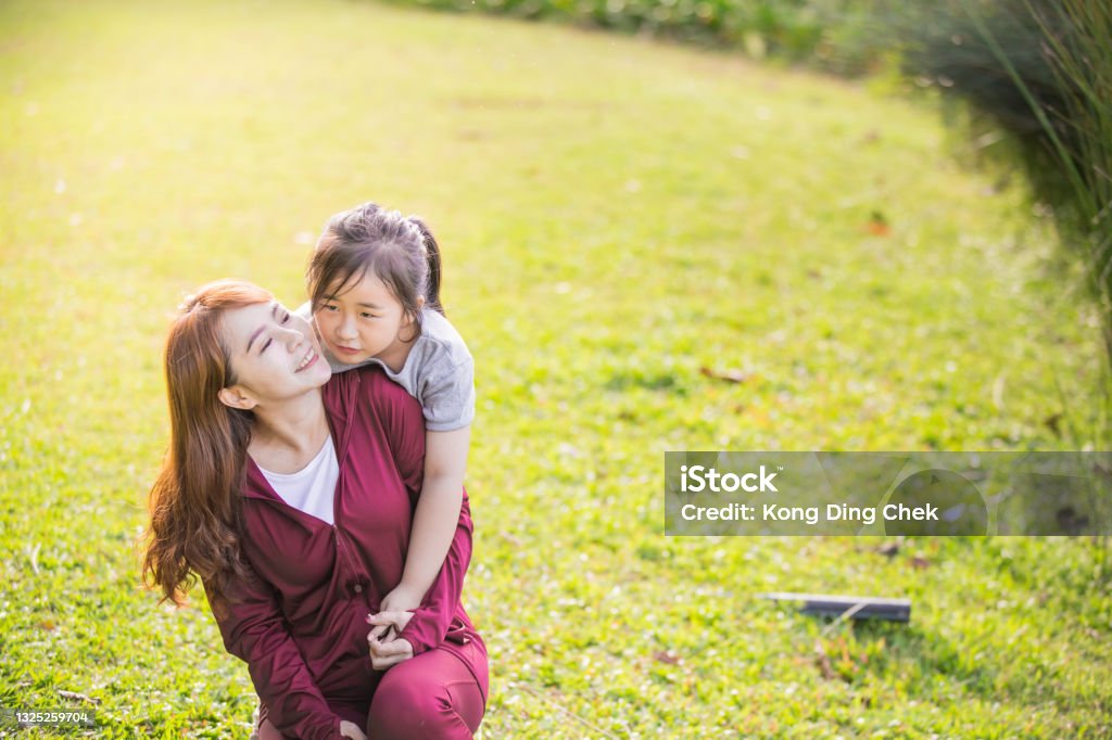 Asian Chinese Mother And Daughter Having Bonding Time In Public Park