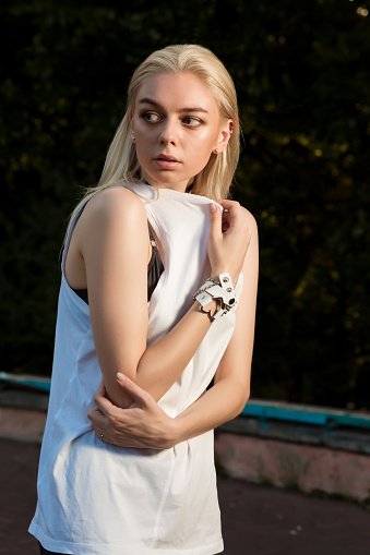 Luxurious Blonde Girl With Long Hair Dressed In Fashionable Clothes And
