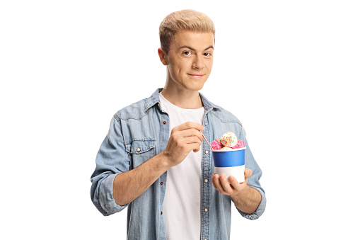 Young Man With Bleached Hair Eating Ice Cream In A Paper Cup Stock