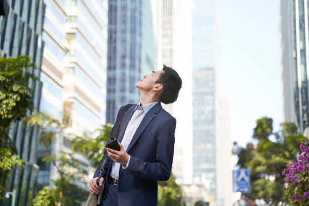 Free Stock Photo of Young Asian businessman executive looking up ...