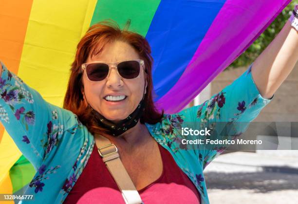 Happy Mature Woman Smiling And Holding A Rainbow Gay Pride Flag Lgbti
