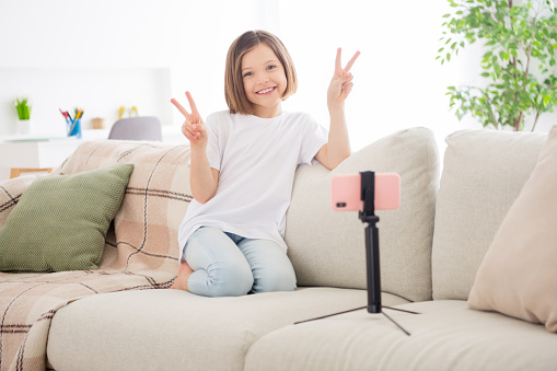 Photo Of Shiny Sweet School Girl Wear White Tshirt Smiling Sitting Sofa
