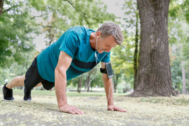 Free Stock Photo of Senior man with headphones on neck doing push-ups ...