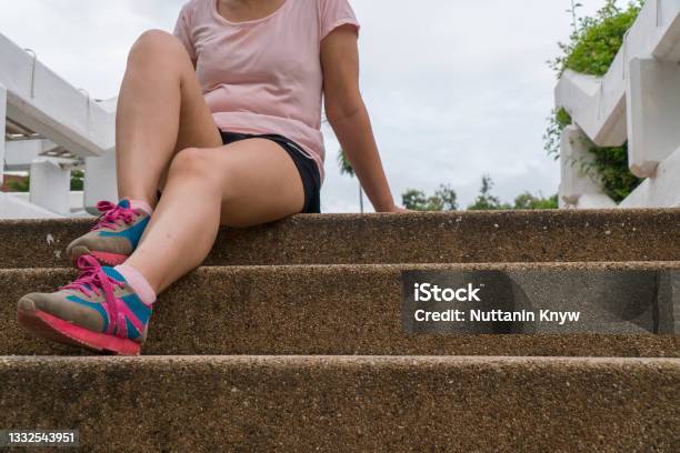 Portrait Of Asian Chubby Woman Sitting On Stairs Of City Street After Running Healthy Runner