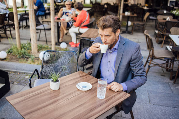 Free Stock Photo of Man with cup of coffee sitting in an outdoor cafe ...
